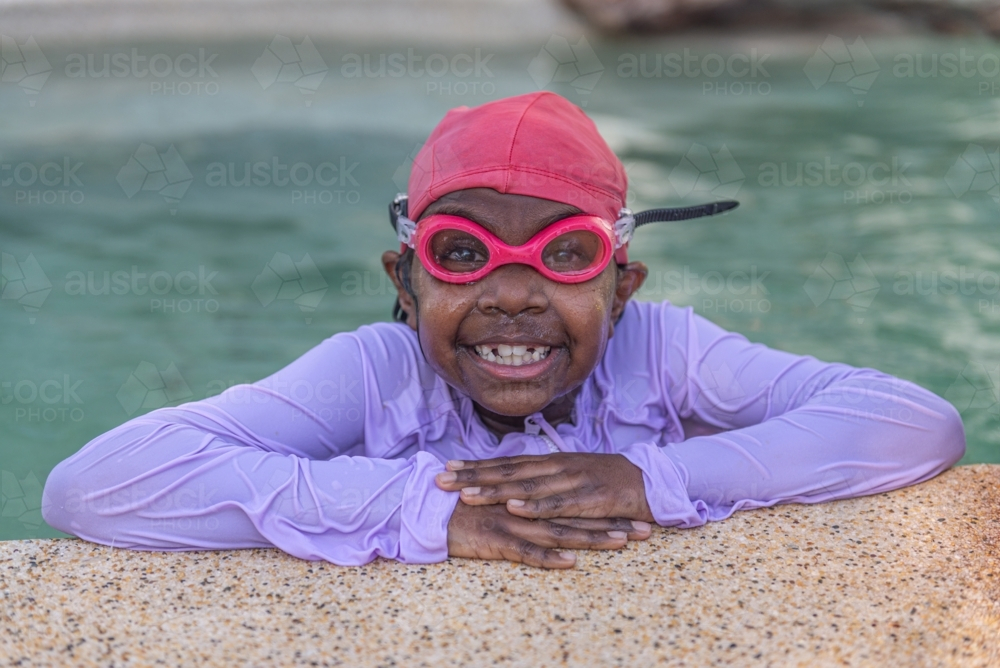 Image of Aboriginal girl with goggles in the pool - Austockphoto