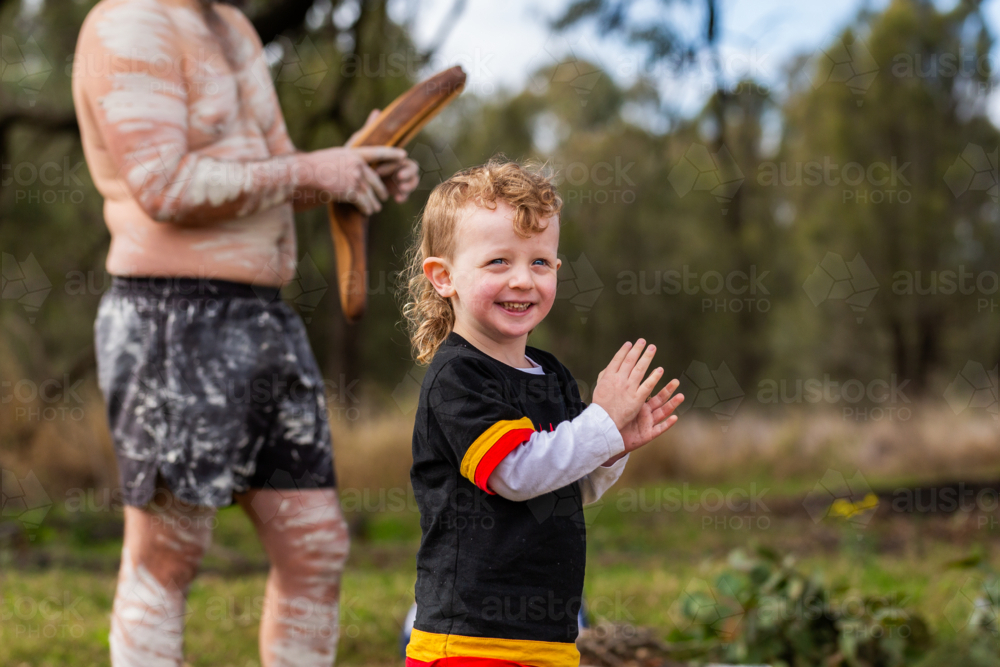 Image of Aboriginal kid at cultural welcome to country event dancing to ...