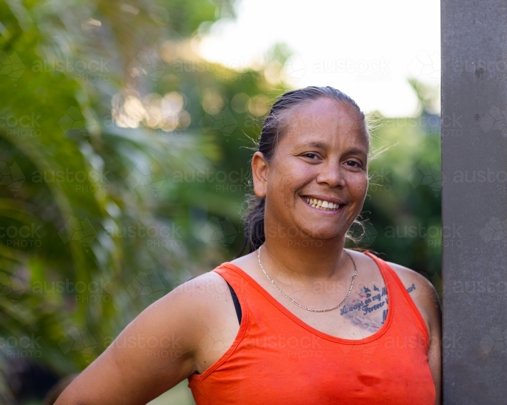 Image of aboriginal lady outside smiling looking at camera - Austockphoto