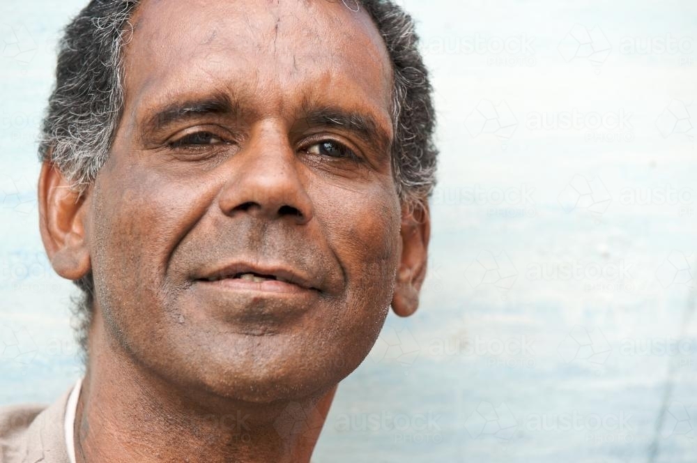 Image of Aboriginal Man Looking at Camera with a Half Smile - Austockphoto