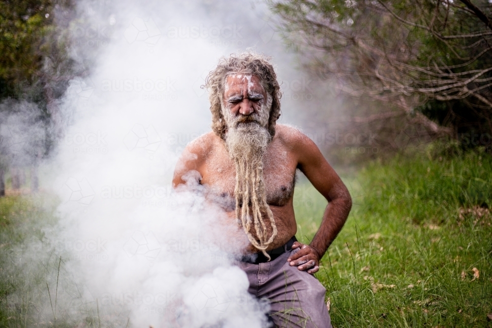 Image of Aboriginal man sitting in smoke at a smoking ceremony ...