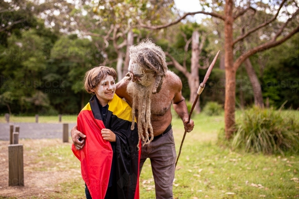 Image of Aboriginal man with his arm around an Aboriginal boy with the ...