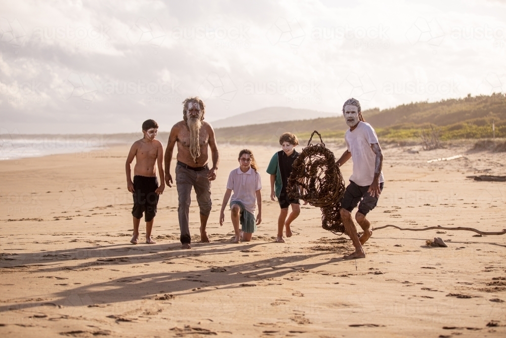 Image of Aboriginal mob at the beach looking at camera - Austockphoto