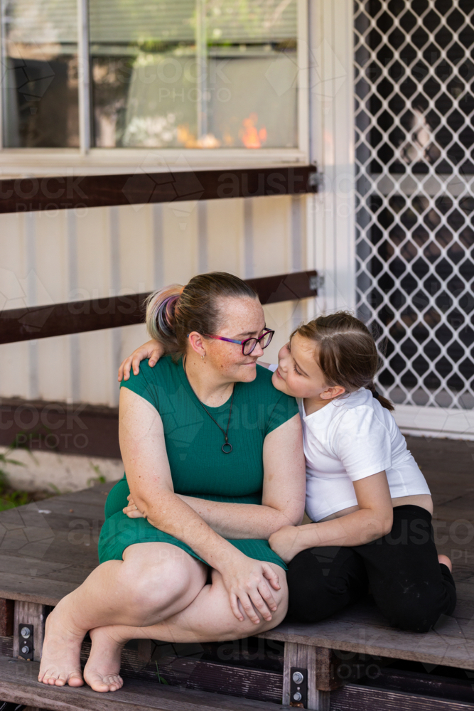 Image of Aboriginal mother and daughter together on front stairs of ...