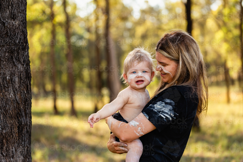 Image of Aboriginal mum cuddling baby boy in Australian bushland ...