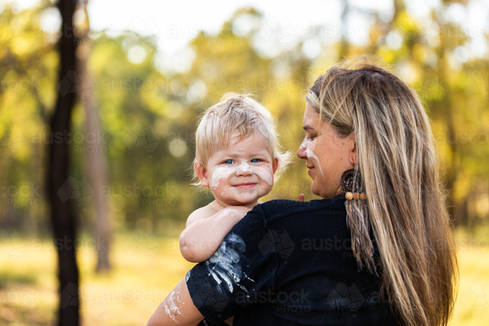 Image of Aboriginal mum cuddling baby boy in Australian bushland ...