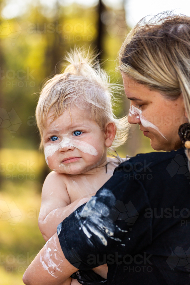 Image of Aboriginal mum cuddling baby boy in Australian bushland ...