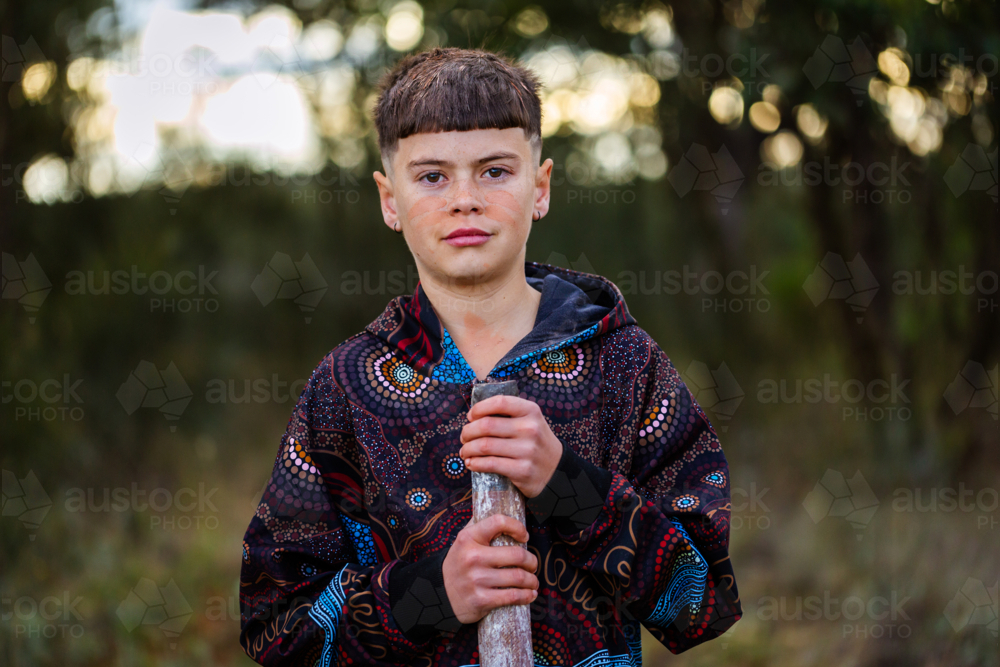Image of aboriginal pre-teen boy holding didgeridoo instrument in ...