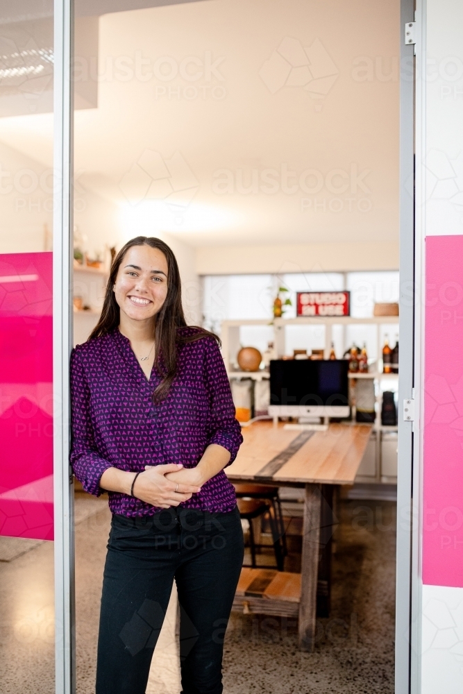 Image of Aboriginal woman smiling at the camera in an office - Austockphoto