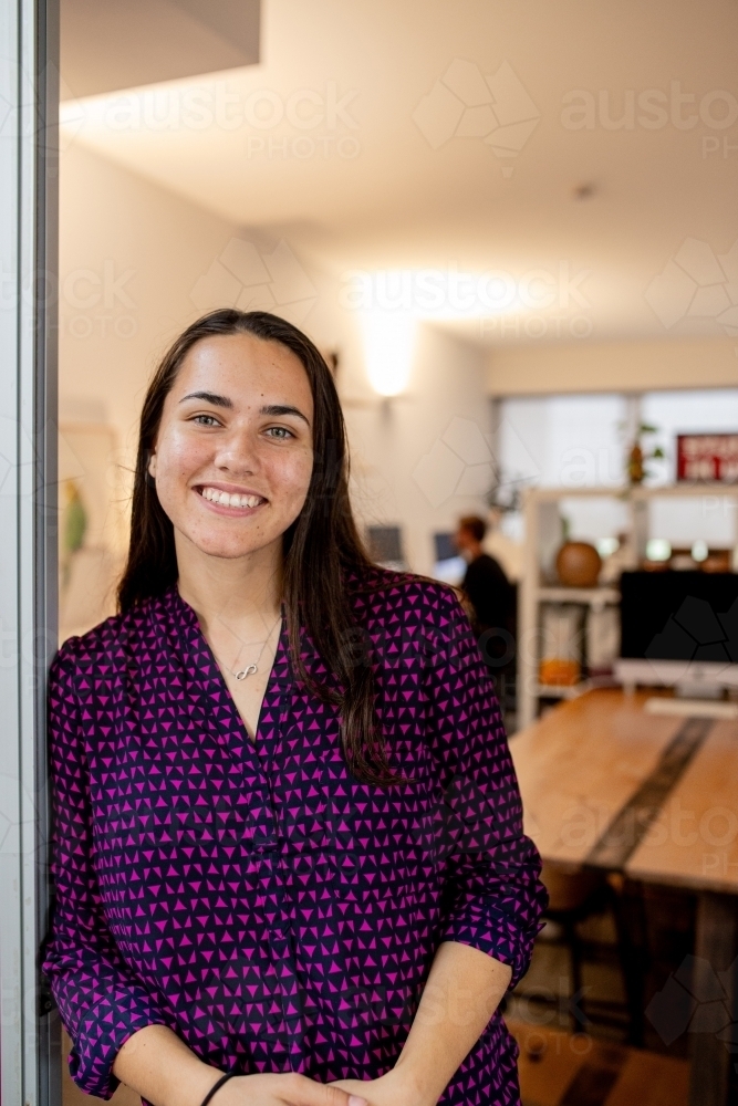 Image of Aboriginal woman smiling at the camera in an office - Austockphoto