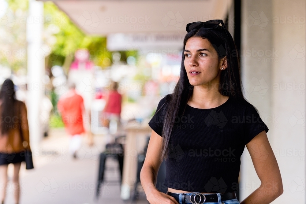 Image of aboriginal woman walking in an urban setting - Austockphoto