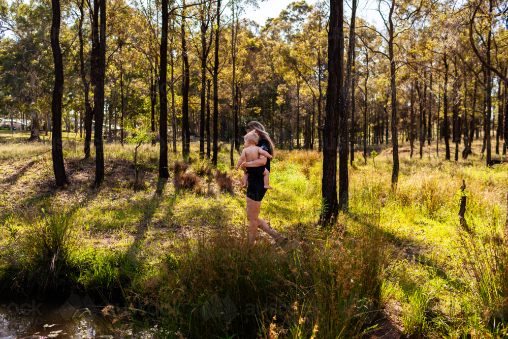 Image of Aboriginal woman with her eight month old baby boy walking ...