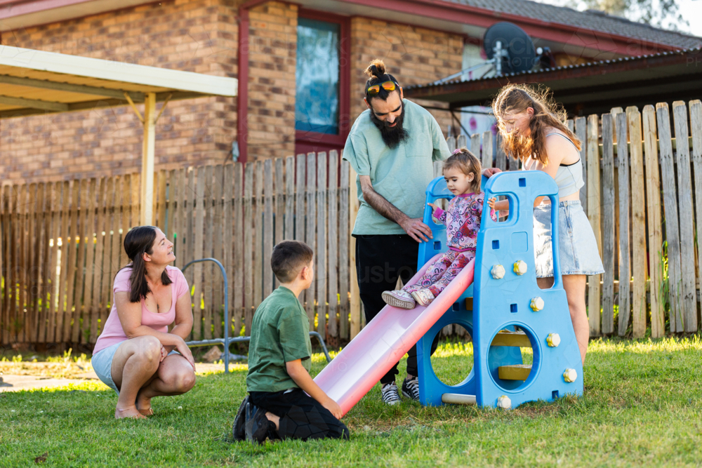 Image of Aboriginal Worimi toddler girl playing on plastic slide in ...