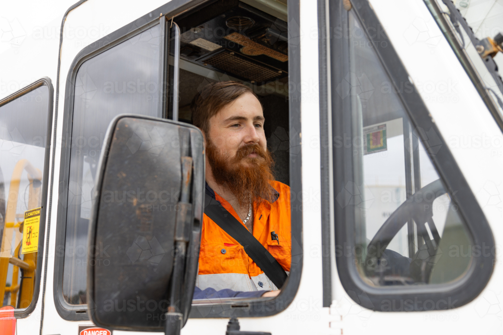 Image of adult worker on the trucks driver seat of crane - Austockphoto