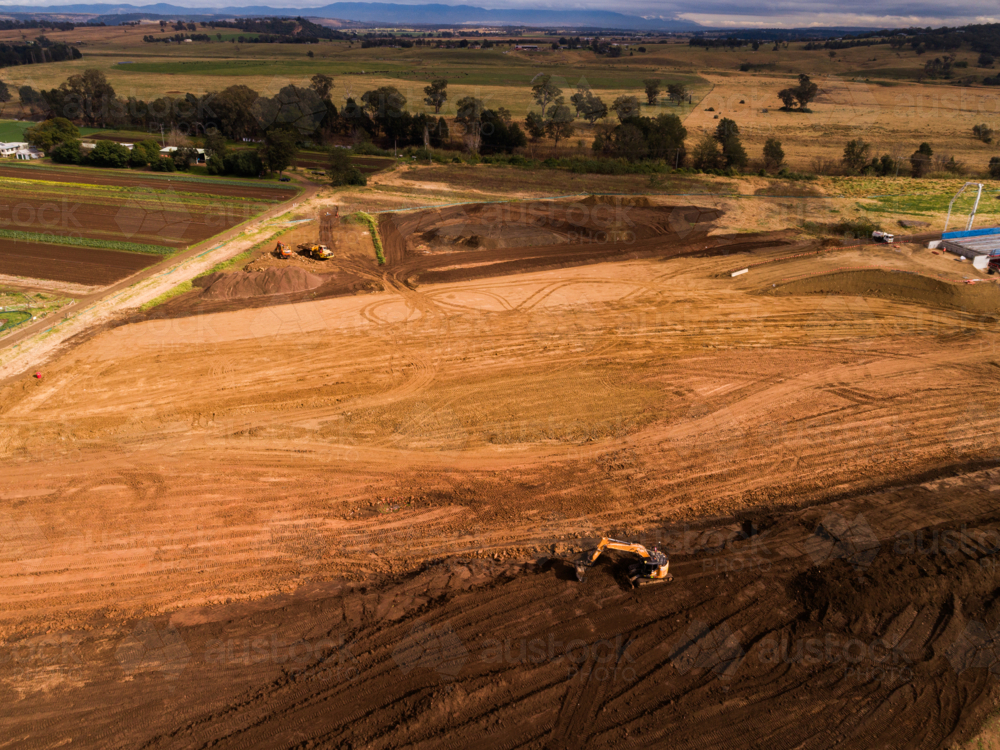 Image of Aerial of construction site with earthworks and excavator ...