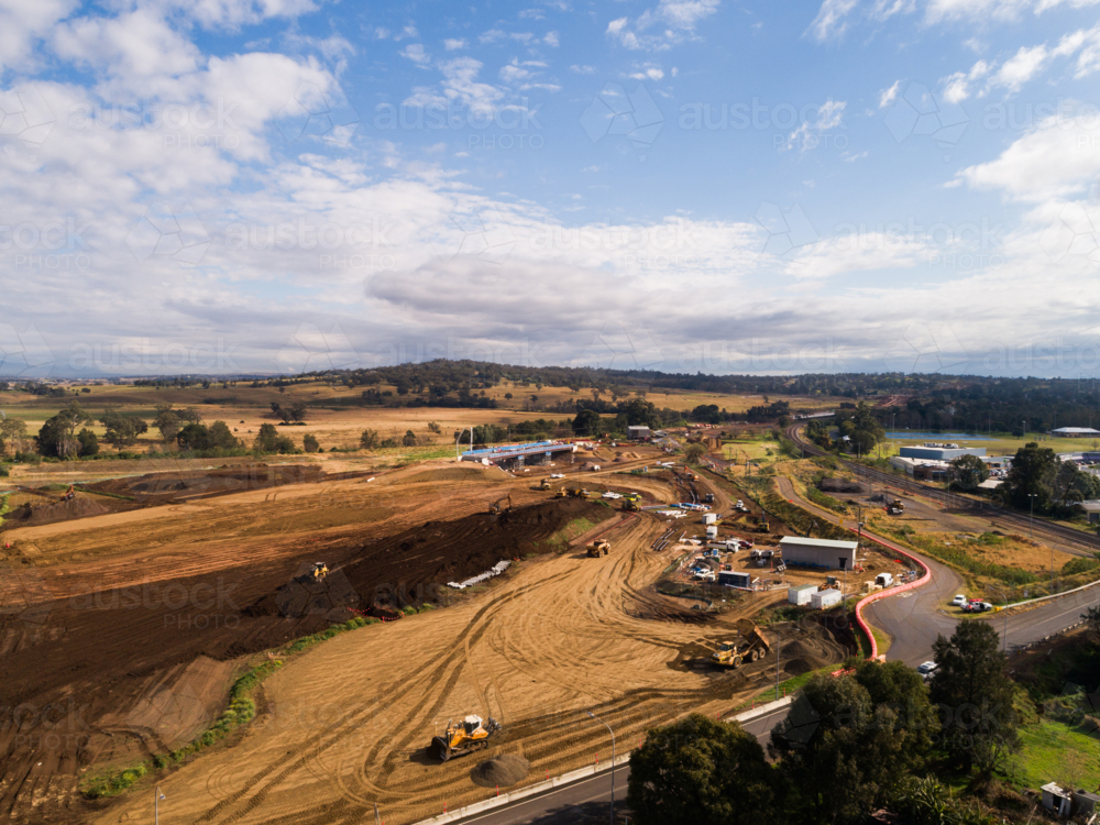 Image of Aerial of construction site with earthworks and machinery on ...