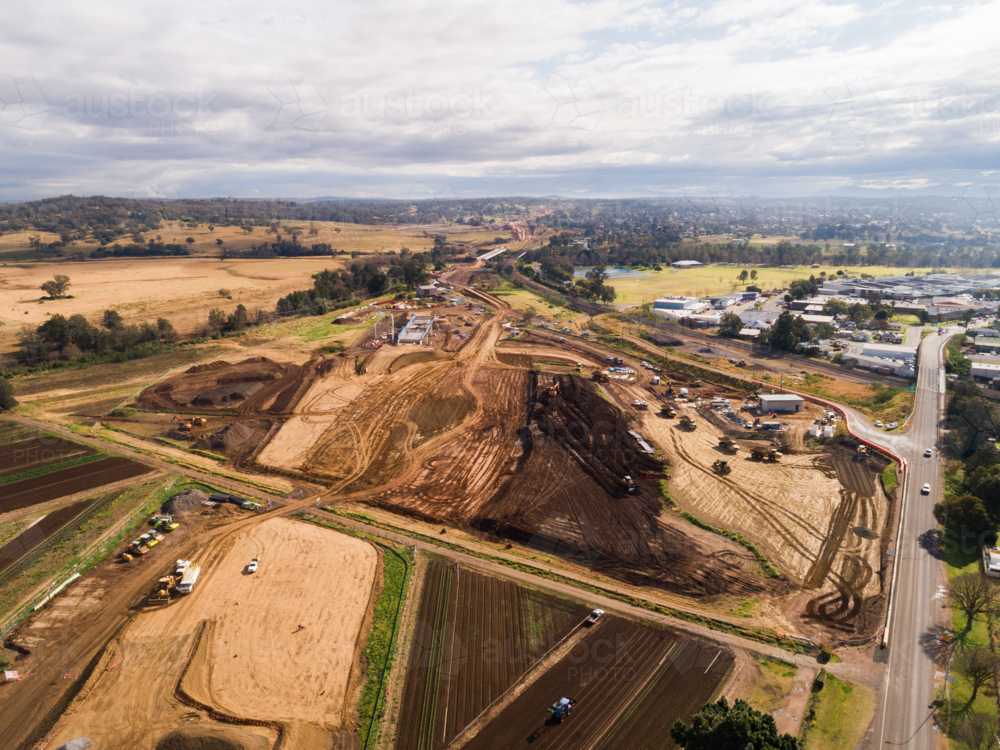 Image of Aerial of construction site with earthworks and machinery on ...