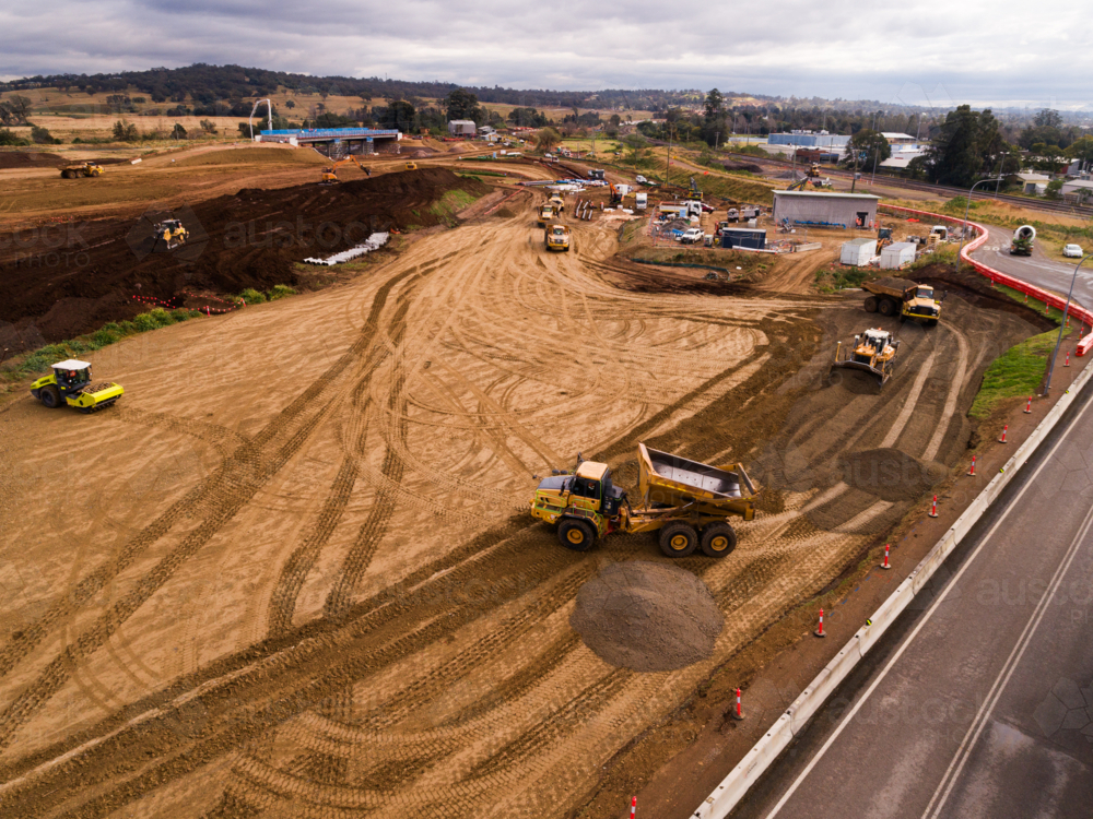 Image of Aerial of construction site with earthworks and machinery on ...