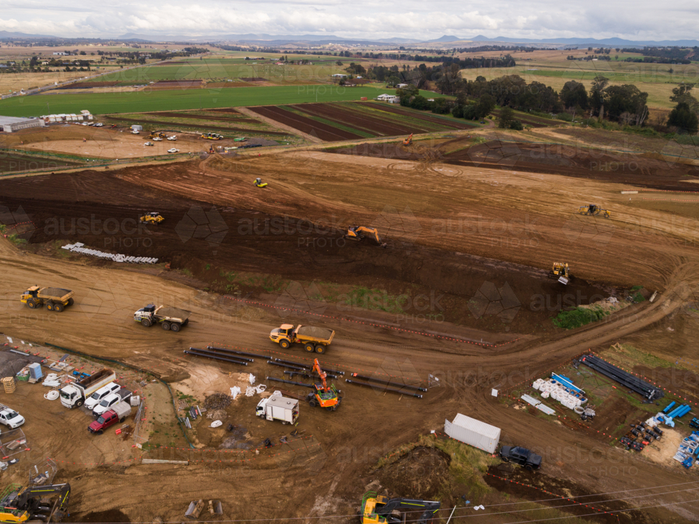 Image of Aerial of construction site with earthworks and machinery on ...