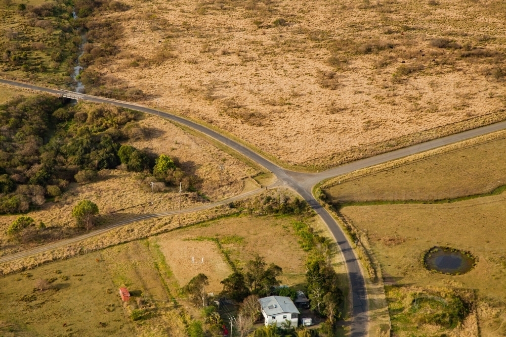 Image of Aerial of intersection of country roads with dam and farm ...