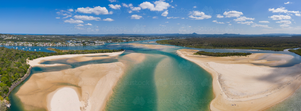 Image of Aerial panorama of a coastal river winding around sand bars ...