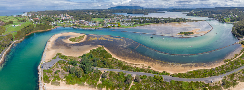 Image of Aerial panorama of a winding river system flowing past a ...