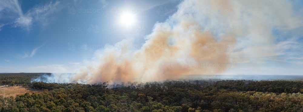Image of Aerial panorama of plumes of brown bushfire smoke rising from ...