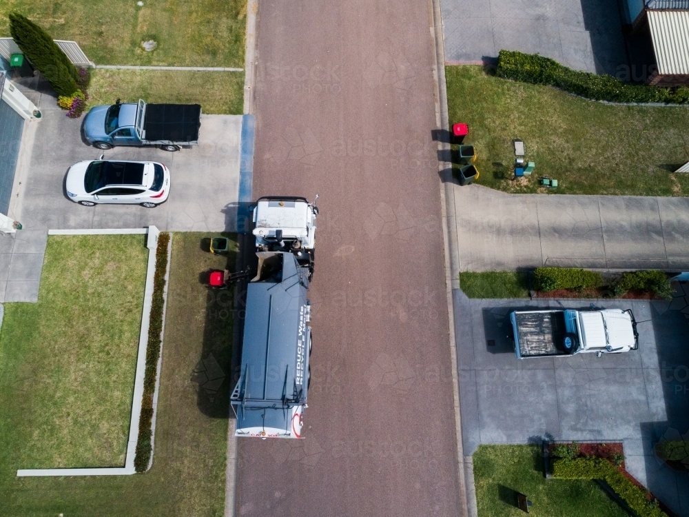 Image of Aerial photo of a garbage truck emptying waste bins along ...