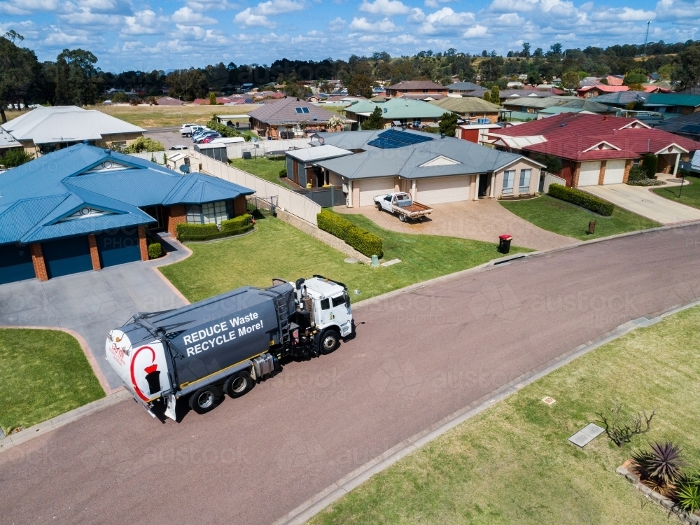 Image of Aerial photo of a garbage truck emptying waste bins along ...