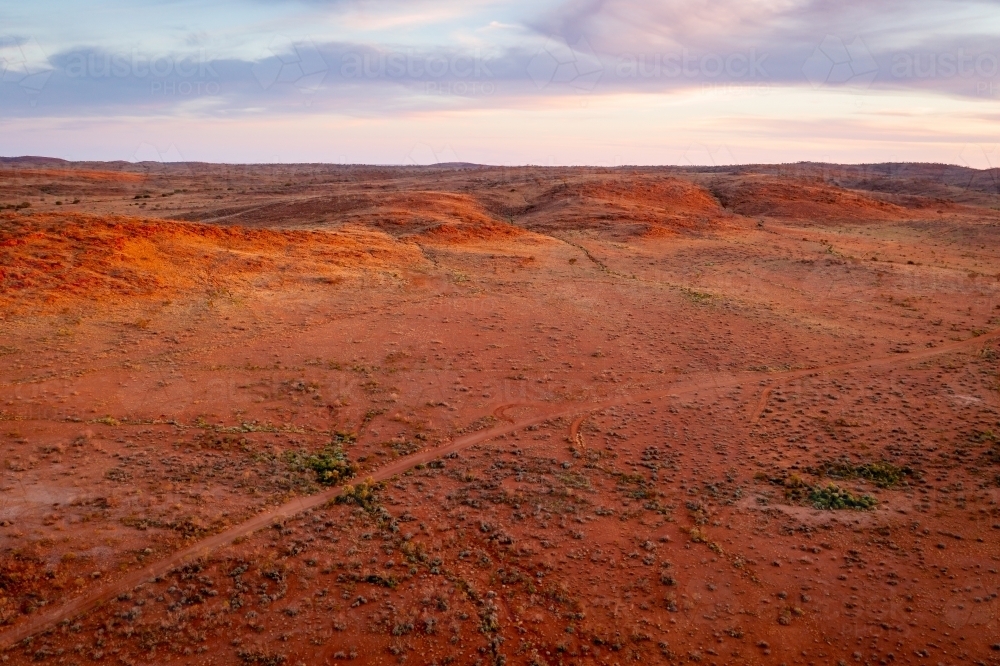 Image of Aerial view a dry orange outback landscape with small hills ...