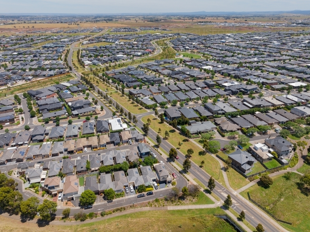Image of Aerial view a suburban road running through an outer city ...
