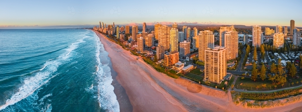 Image of Aerial view at sunrise of high rise buildings along a beach ...