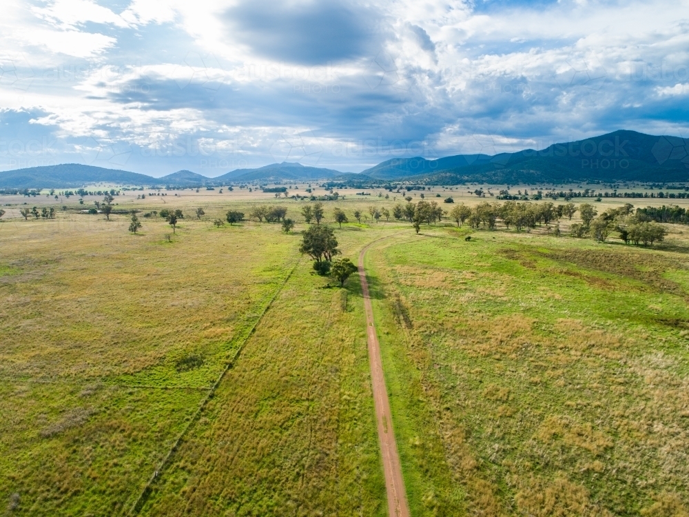 Image of Aerial view down long farm driveway in good season with green ...