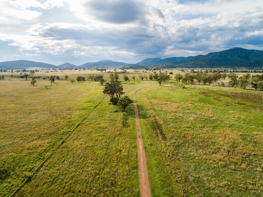 Image of Aerial view down long farm driveway in good season with green ...