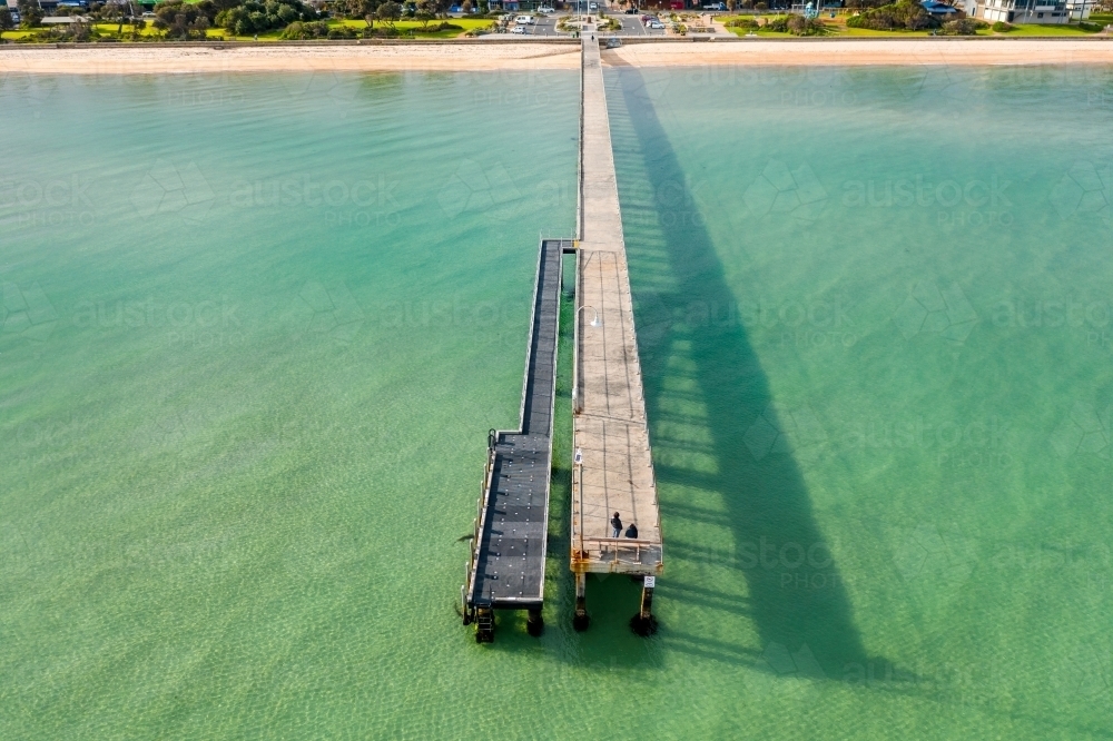 Image of Aerial view looking back along a long narrow jetty towards the ...