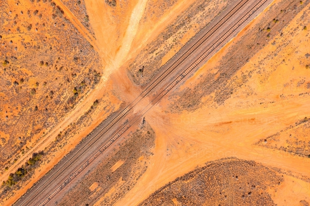Image of aerial view looking down on railway line with level crossing ...