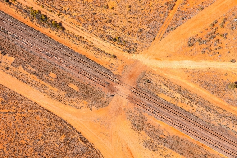 Image of aerial view looking down on railway line with level crossing ...