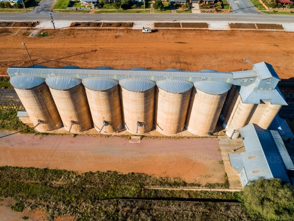 Image of Aerial view looking down on rural silos in a row beside ...