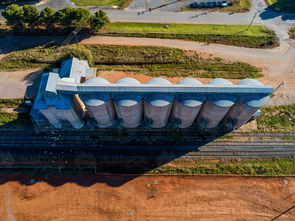 Image of Aerial view looking down on rural silos in a row beside ...