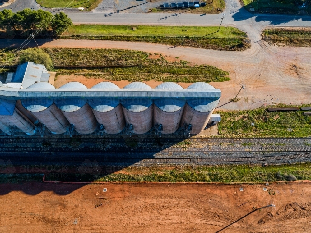 Image of Aerial view looking down on rural silos in a row beside ...