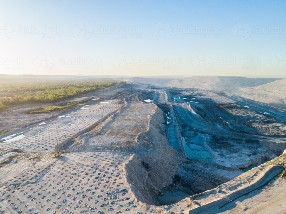 Image of Aerial view looking towards dusty open cut coal mine pit ...