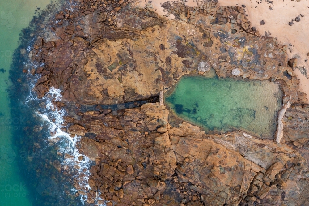 Image of Aerial view of a bathing pool in a rocky coastline - Austockphoto