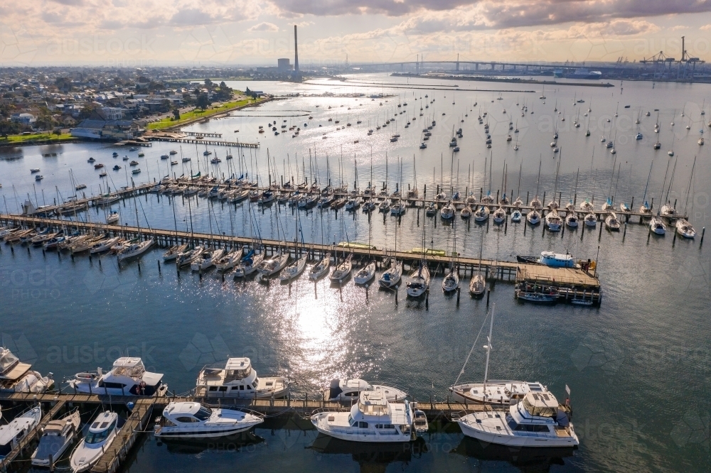 Image of Aerial view of a bay side marina with rows of boats tied to ...