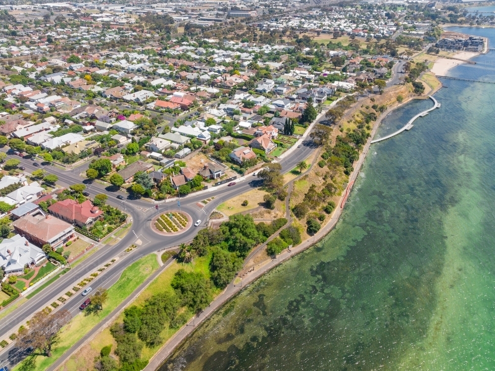 Image of Aerial view of a bay side suburb behind a busy arterial road ...