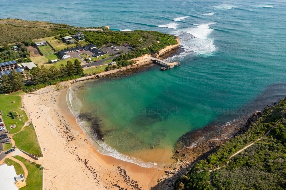 Image of Aerial view of a beach and a calm coastal inlet - Austockphoto