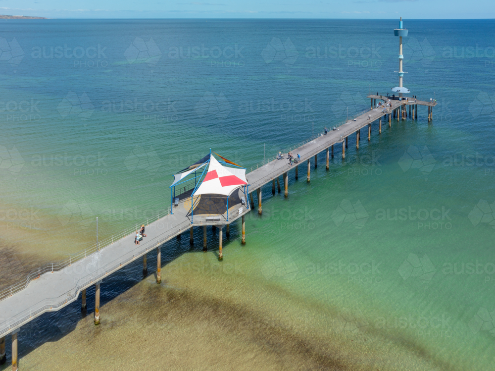 Image of Aerial view of a beacon tower on the end of a coastal pier ...