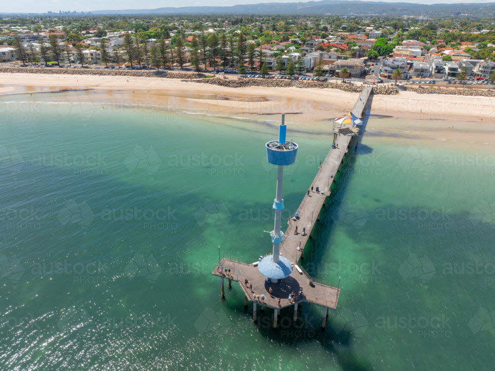 Image of Aerial view of a beacon tower on the end of a coastal pier ...