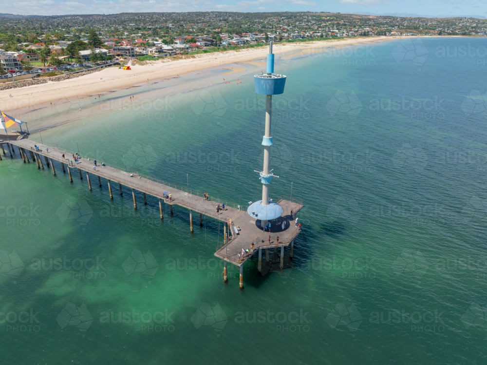 Image of Aerial view of a beacon tower on the end of a coastal pier ...