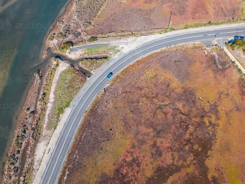 Image of Aerial view of a bend in a road along side a river - Austockphoto