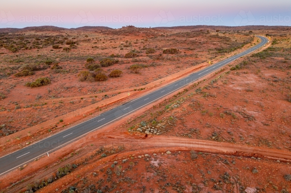 Image of Aerial view of a bitumen road running diagonally through and ...